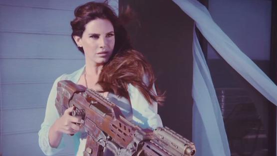 Watch A Machine Gun-Toting Lana Del Rey Obliterate A Chopper In New ...